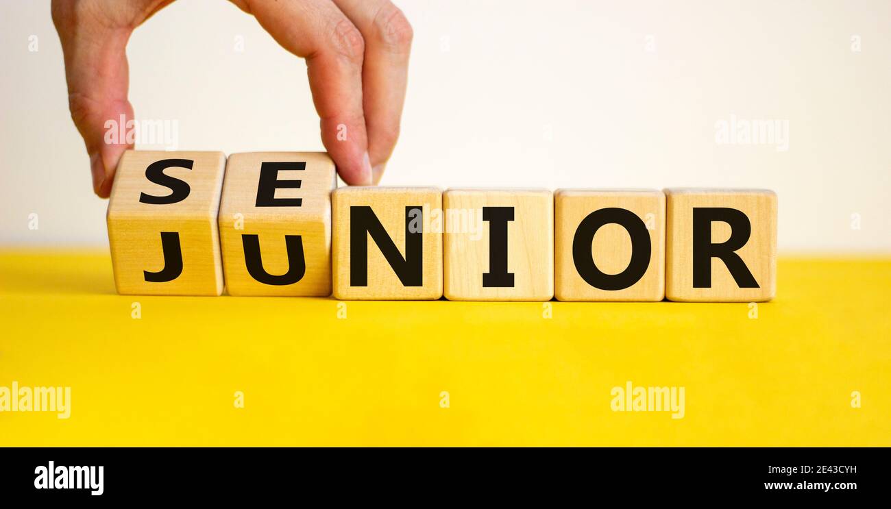 From junior to senior symbol. Businessman turns cubes and changes the ...
