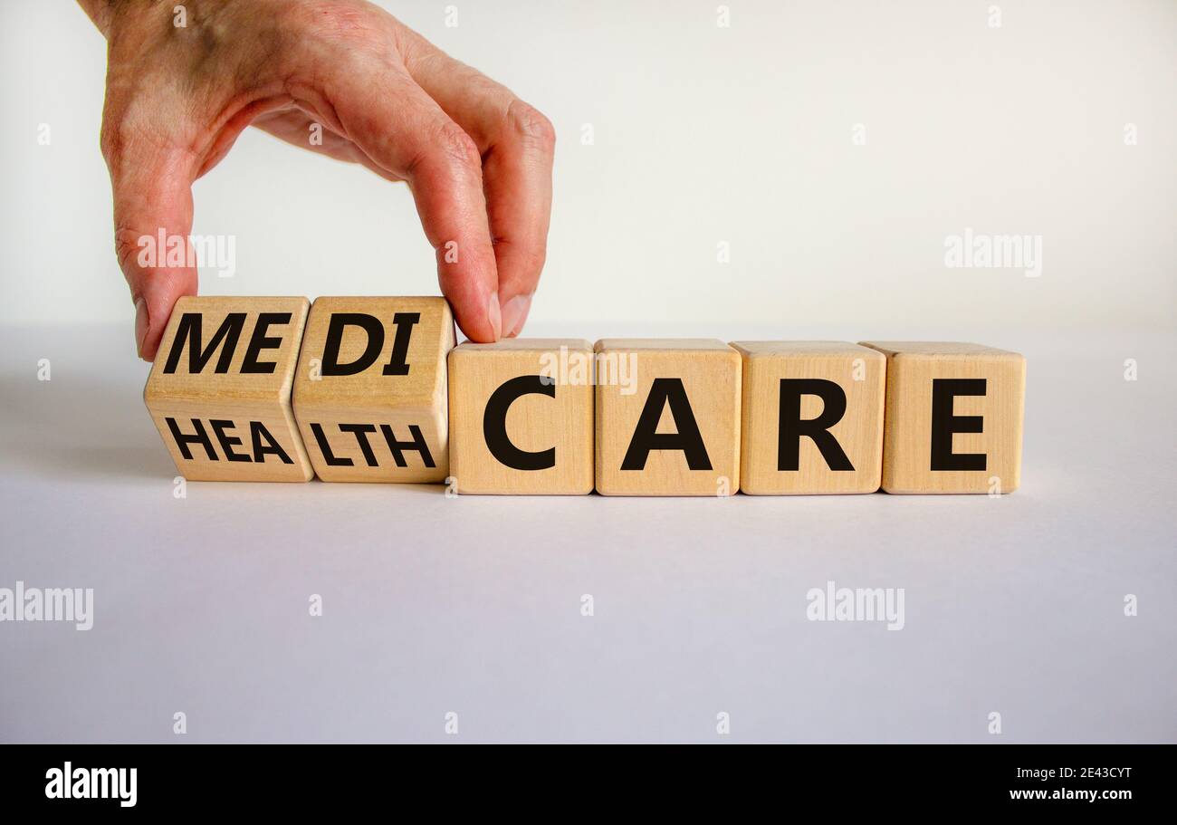 Medicare or healthcare symbol. Doctor turns cubes, changes the word ...