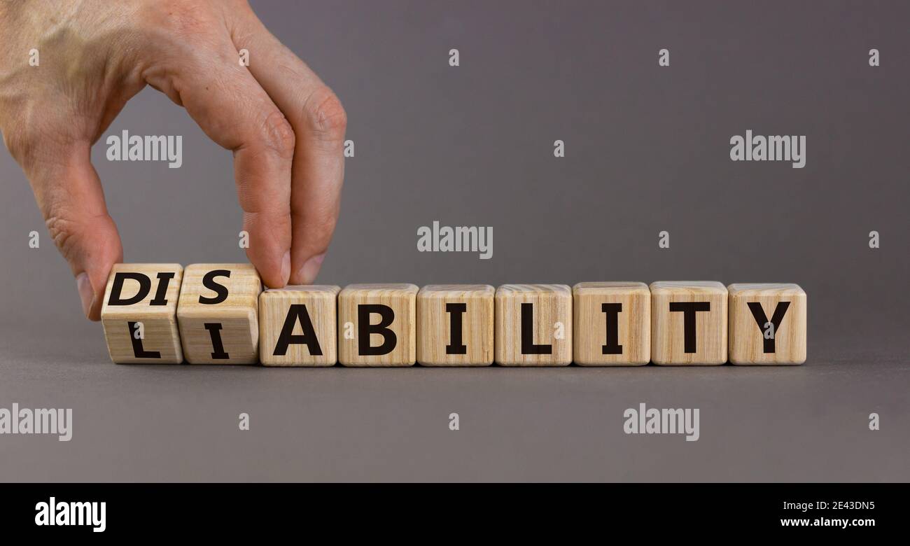 Liability or disability symbol. Businessman turns cubes and changes the ...