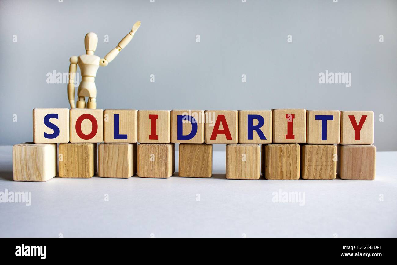 Time to solidarity symbol. Concept word solidarity on wooden cubes on a ...