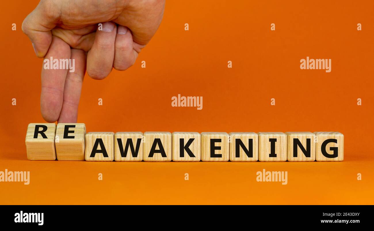 Reawakening symbol. Businessman turns cubes and changes the word ...