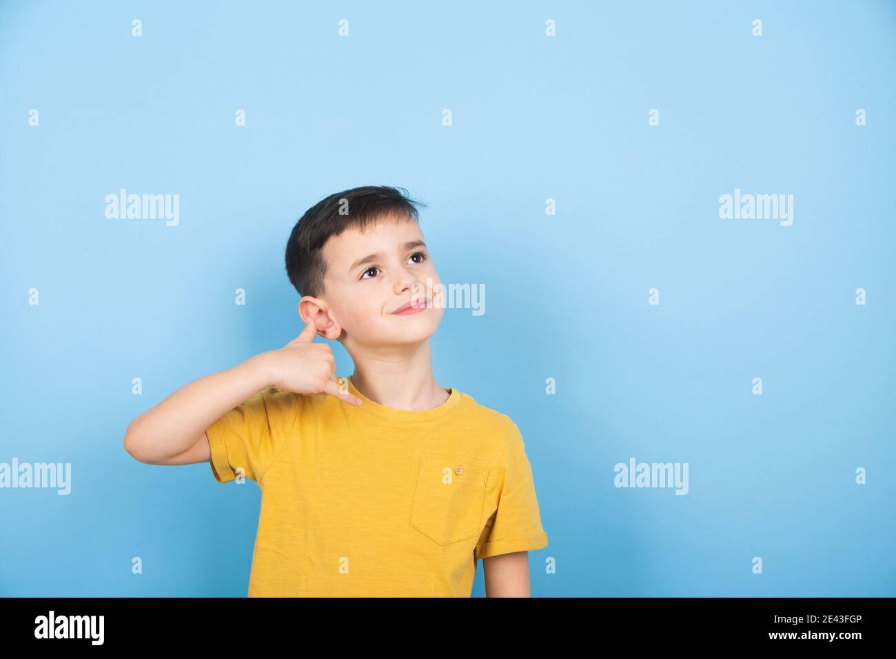 Child imitates a telephone conversation, makes a telephone call gesture ...