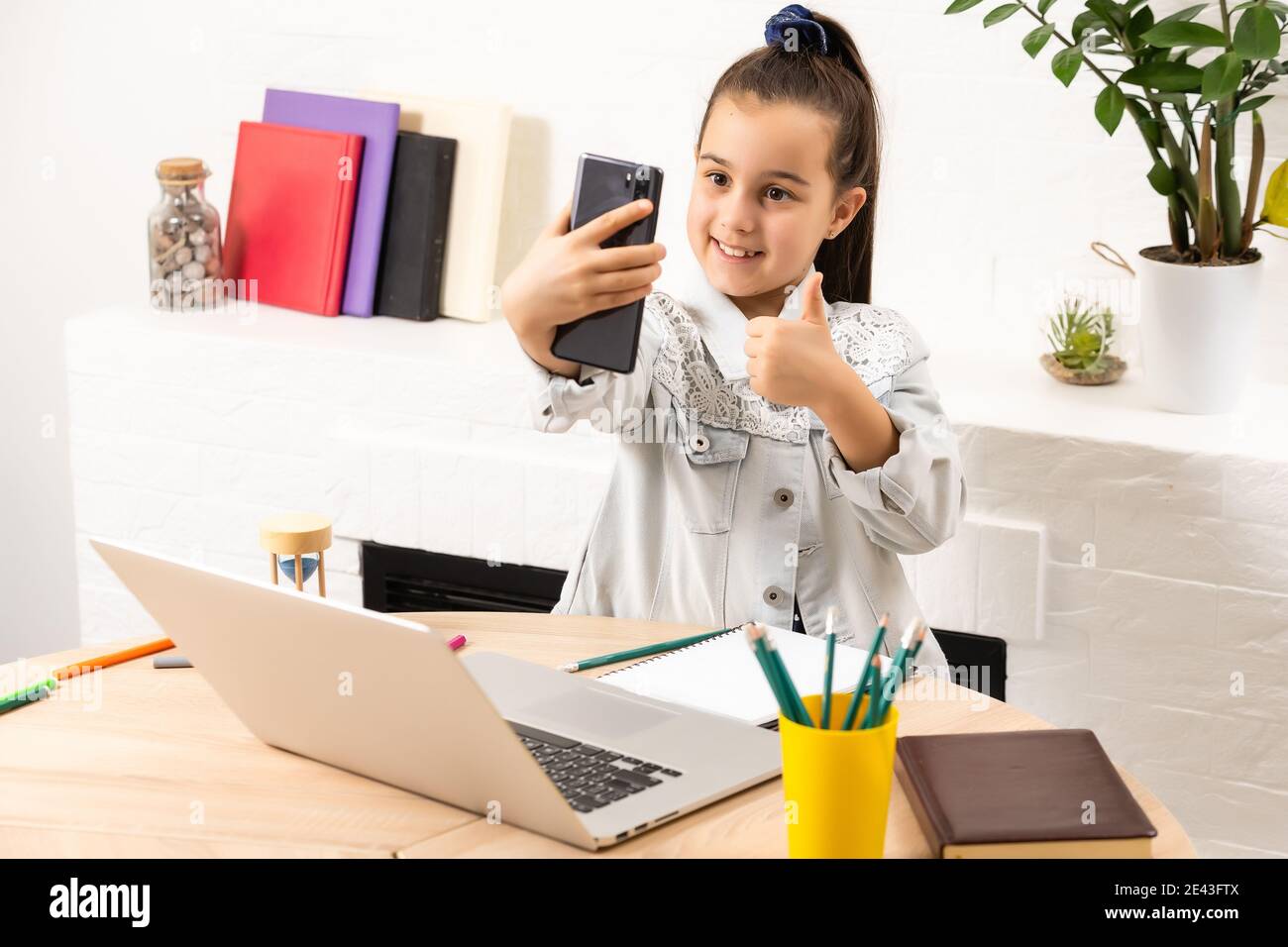 people, children and technology concept - girl with laptop computer and ...