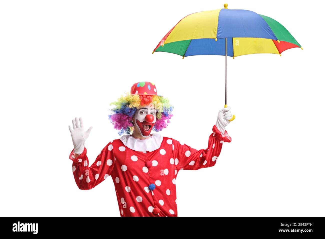 Happy clown holding an umbrella and waving isolated on white background ...