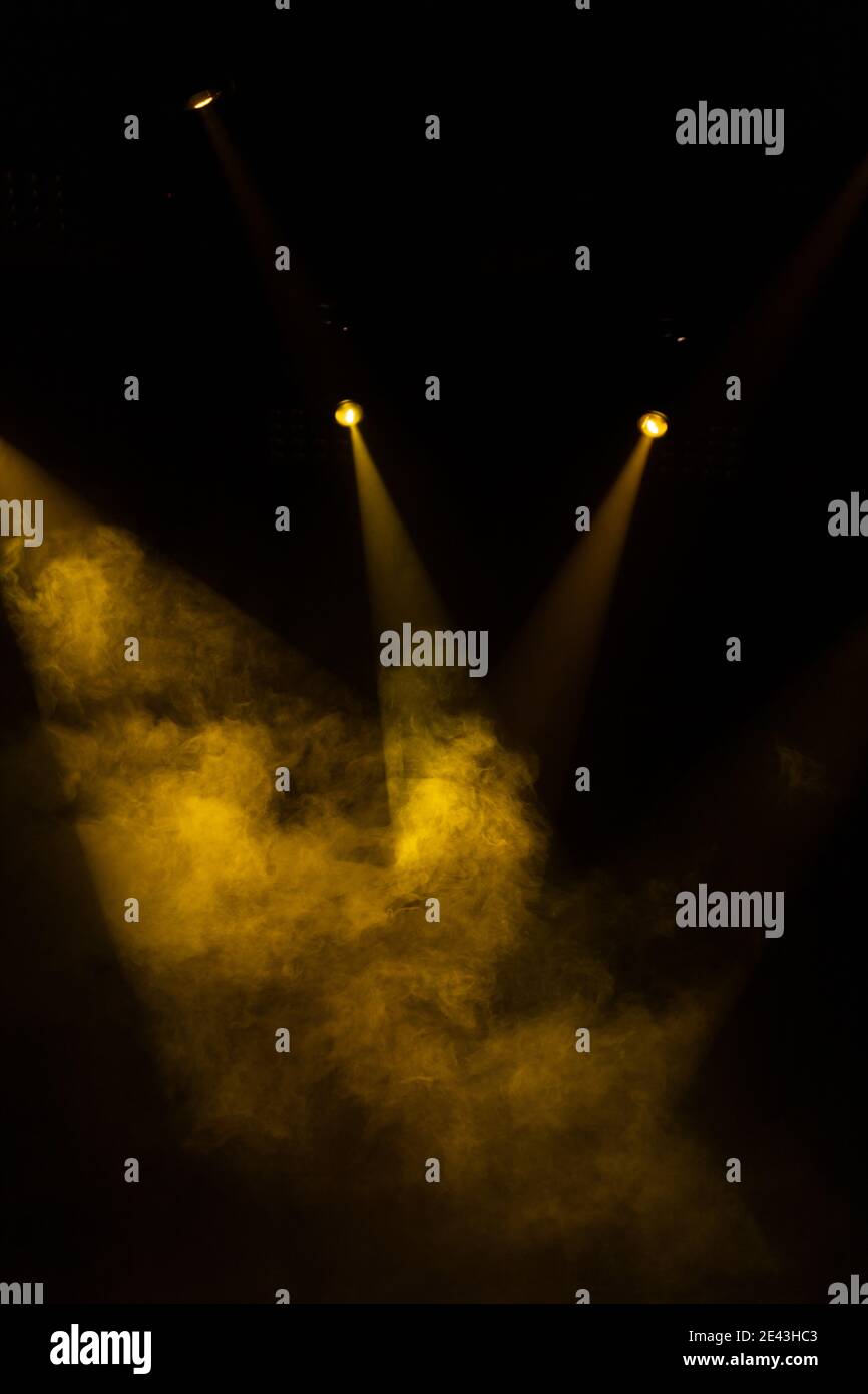 An empty stage of the theater, lit by spotlights and smoke before the ...