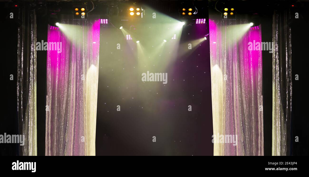 An empty stage of the theater, lit by spotlights and smoke before the ...