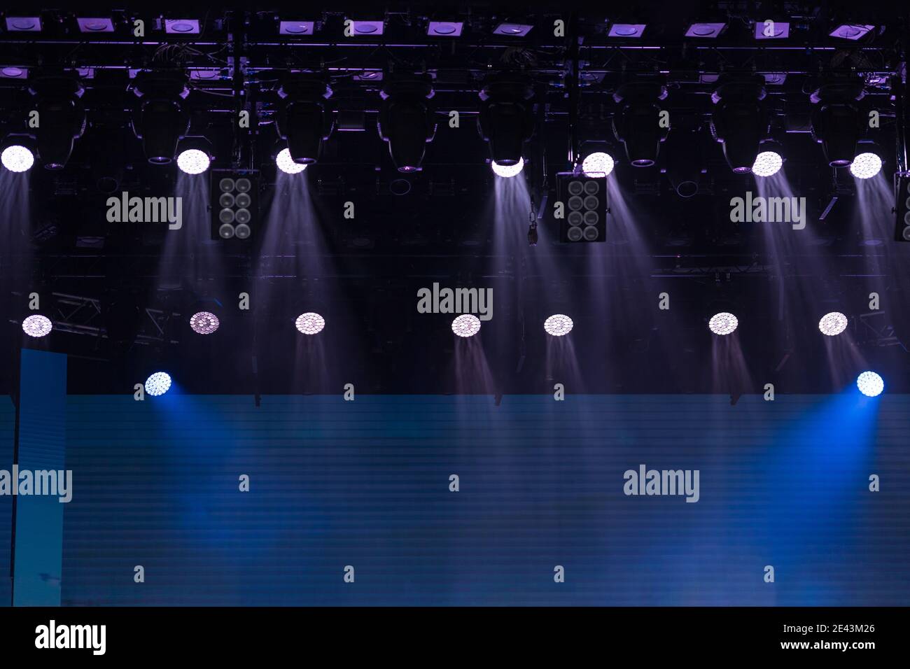 An empty stage of the theater, lit by spotlights and smoke before the ...