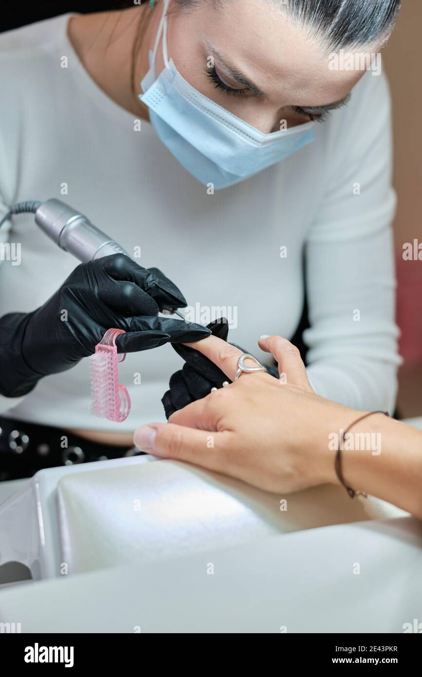 Manicure master in mask gloves hi-res stock photography and images - Alamy