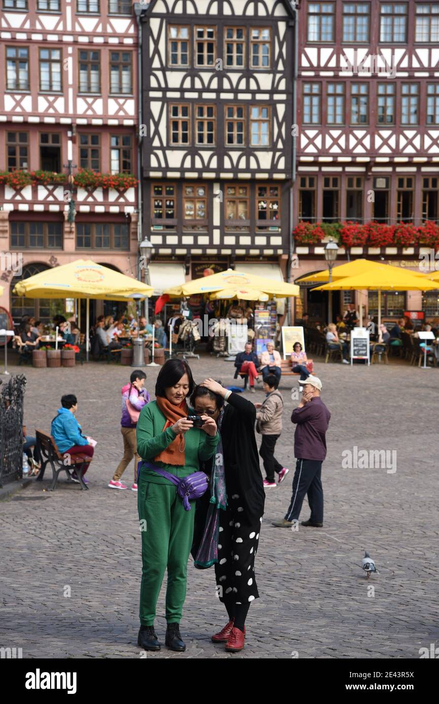 Tourist asian people taking photos at the landmark of Romerberg square ...