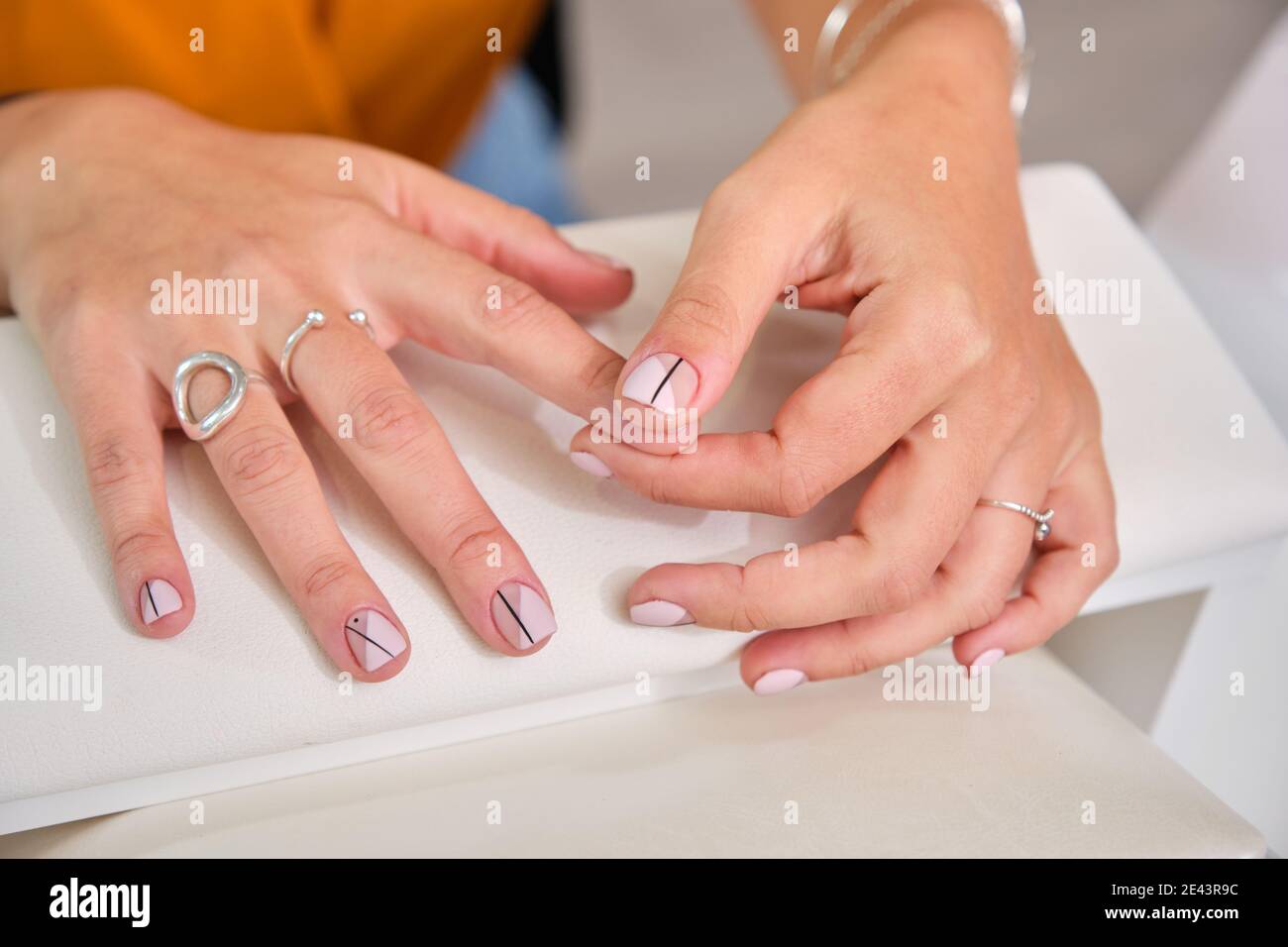 Crop anonymous female client keeping palms on hand rest stand during ...