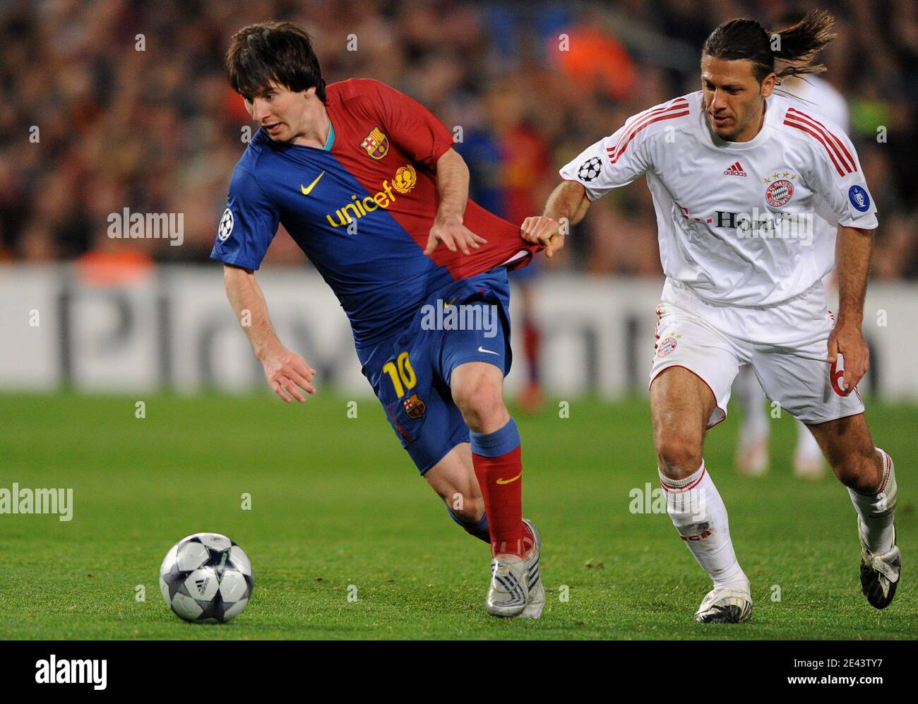 Barcelona's Lionel Messi is pulled by Bayern Munich's Martin Demichelis ...