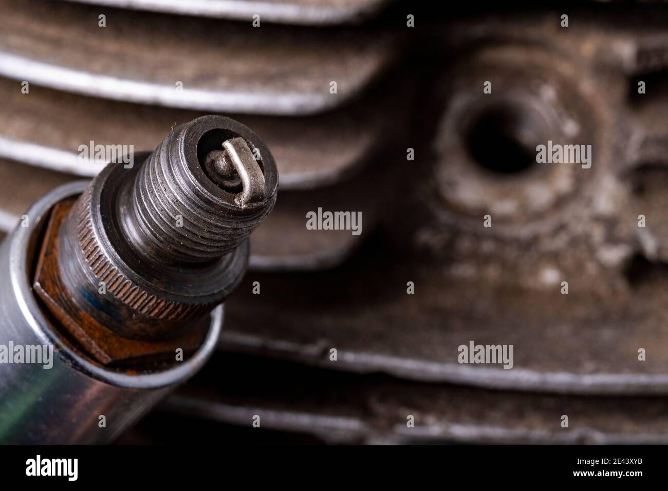 Spark plug on the background of the internal combustion engine. Minor ...