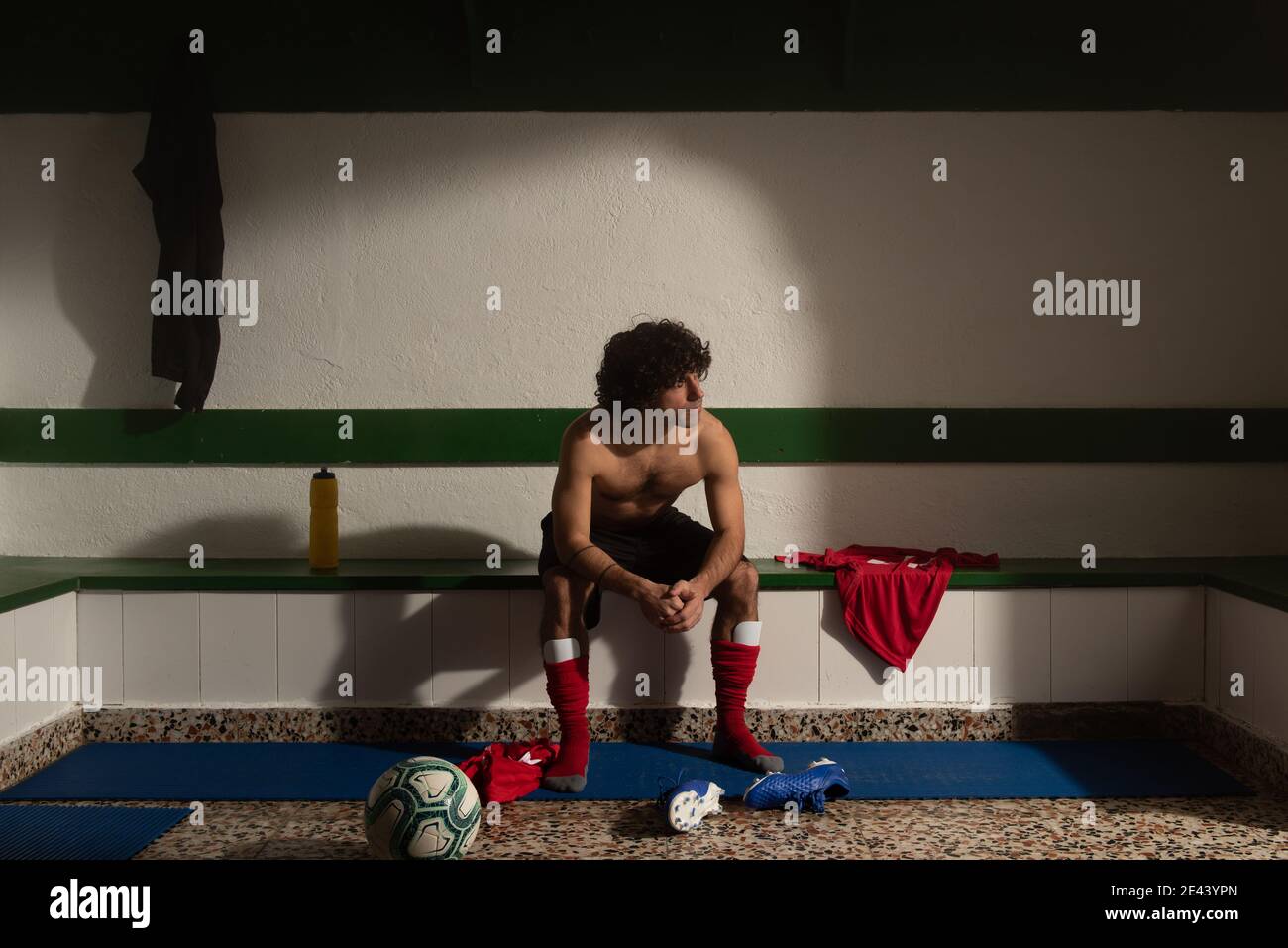 A football player in dressing room with sports uniform Stock Photo - Alamy