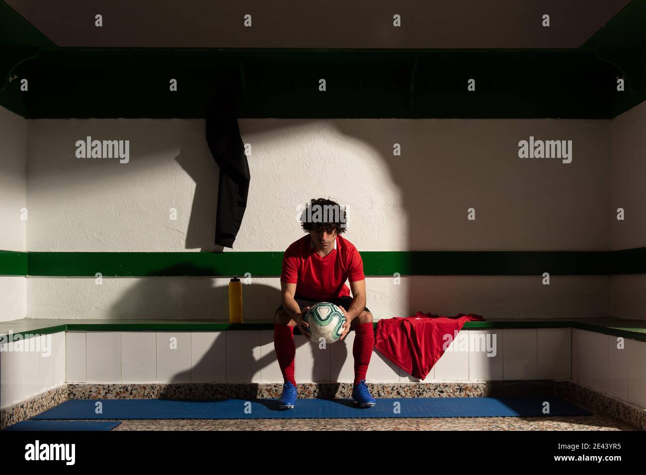 A football player in dressing room with sports uniform Stock Photo - Alamy