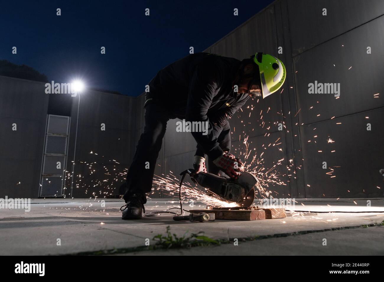 Full body of unrecognizable male welder in protective helmet and ...