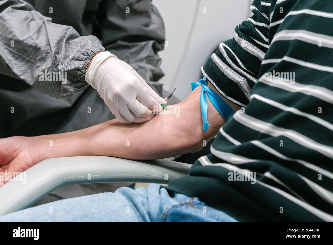Professional female medical specialist in protective uniform preparing ...