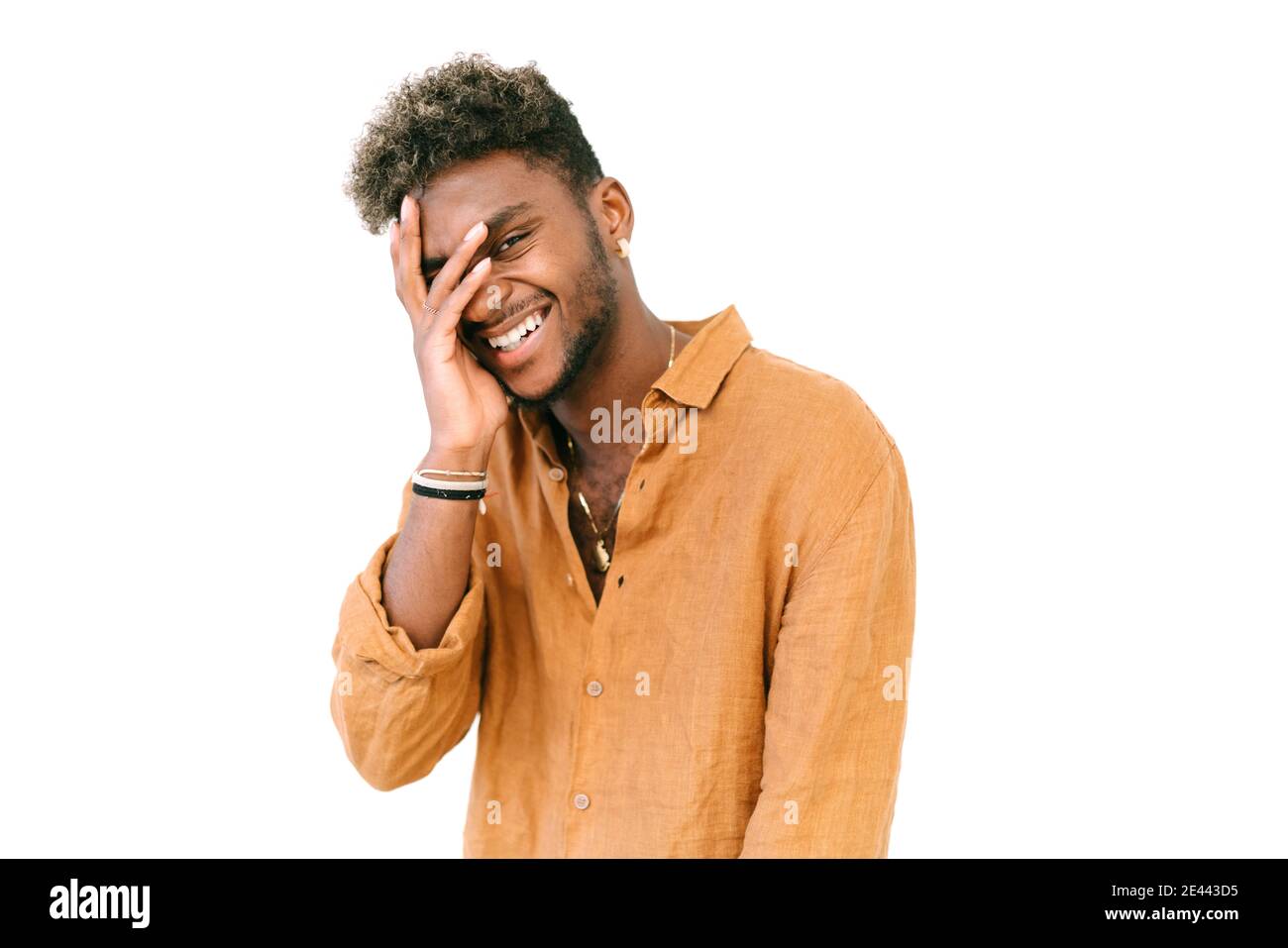 Handsome shy or ashamed young African American guy in casual wear ...