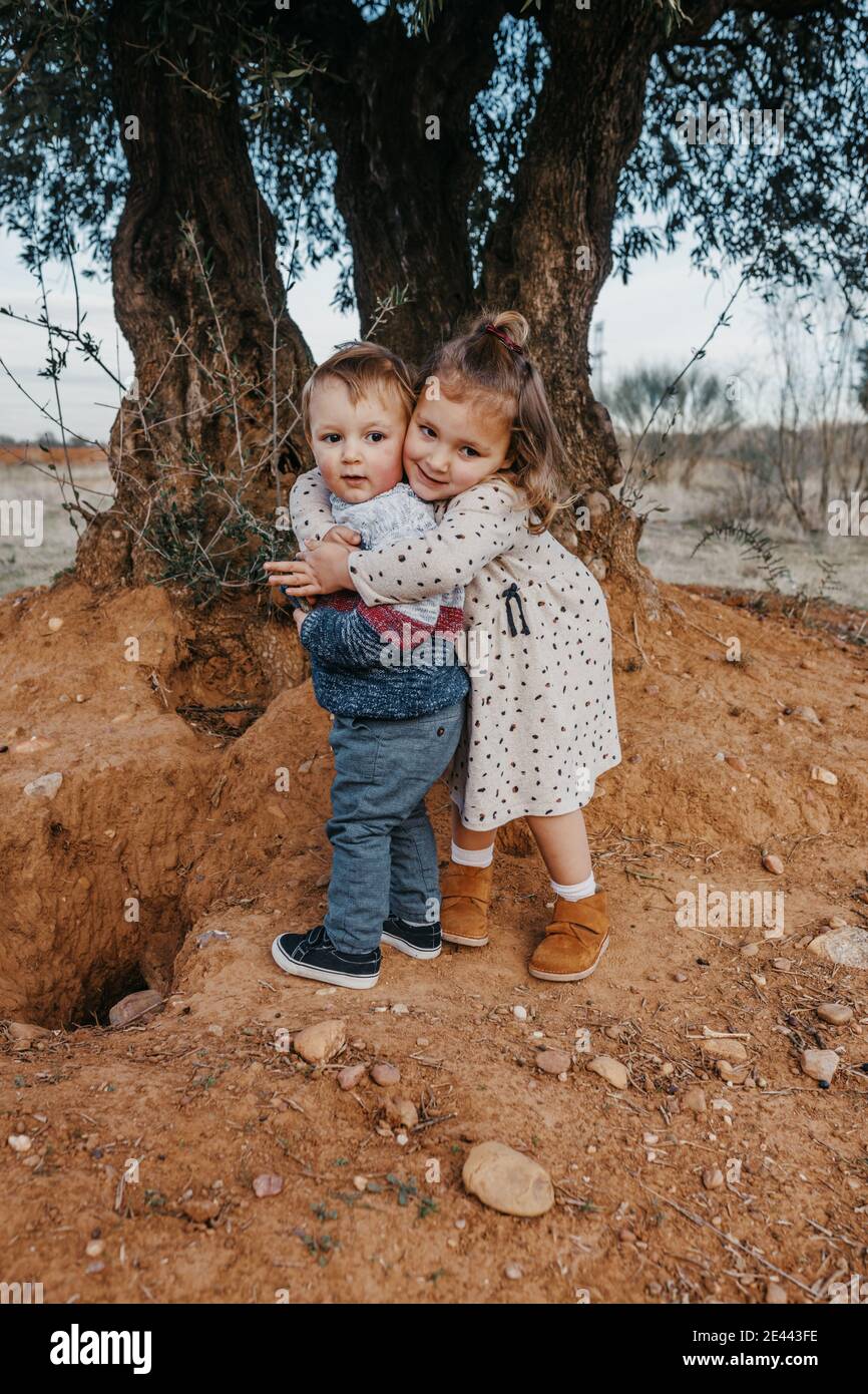 Brother sister cuddling hi-res stock photography and images - Alamy