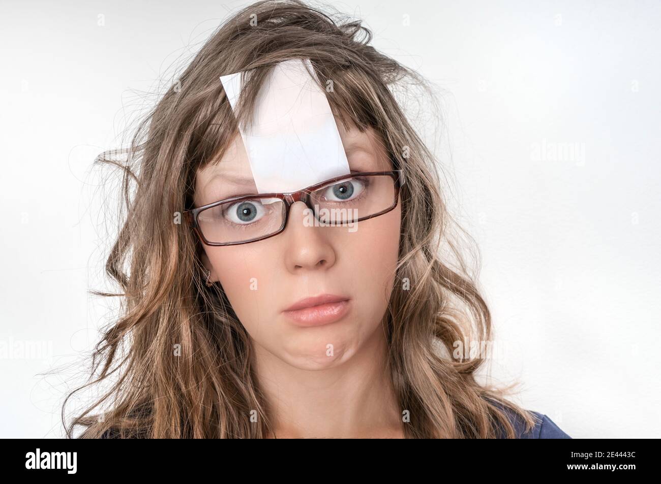 Portrait of a funny woman with blank white sticky paper over her ...