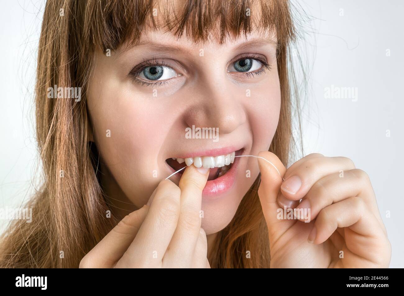 Woman flossing teeth with dental floss - oral and teeth hygiene Stock ...