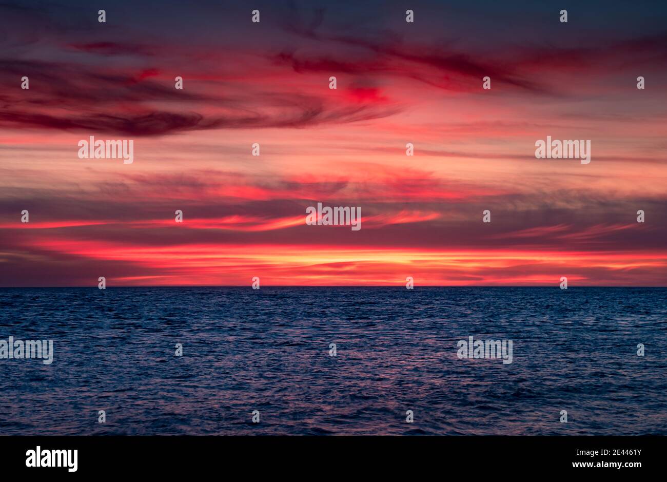 Breathtaking view of vibrant sundown sky over wavy sea in evening in ...