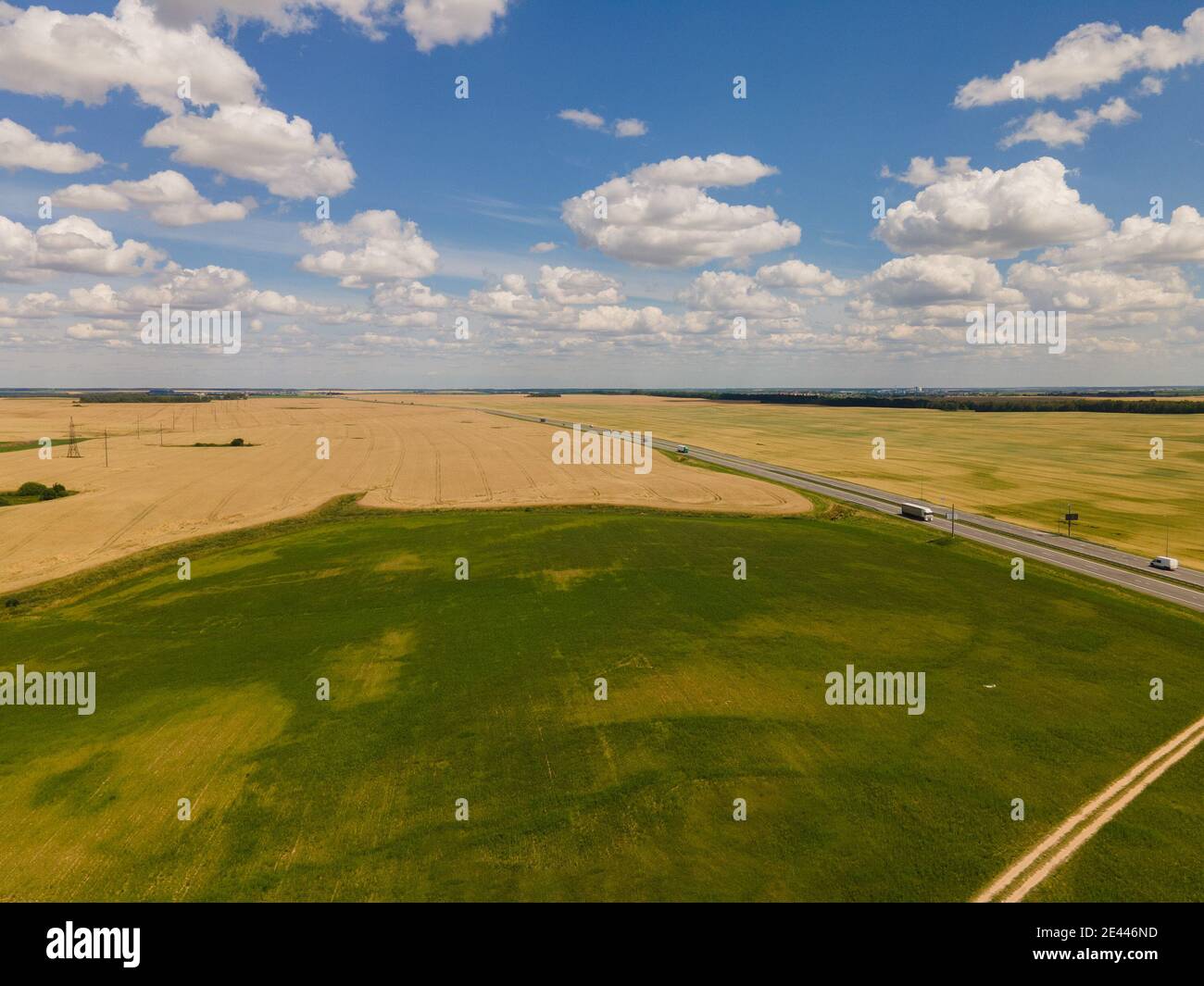 View from a flying drone, a field with green grass on a summer day ...