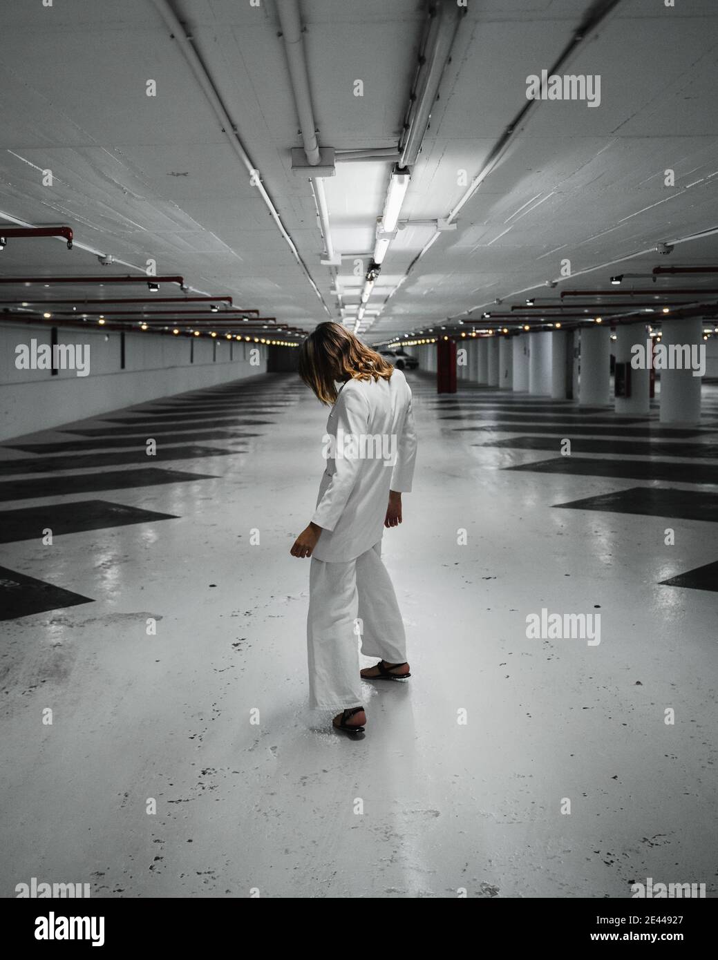 Side view of anonymous lady in stylish total white outfit standing in ...