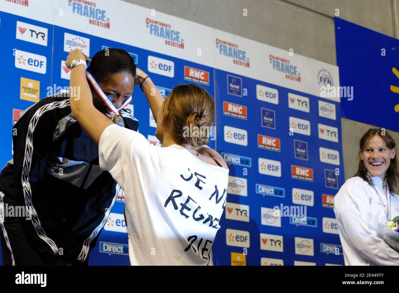 French swim star Laure Manaudou (down) gives the medal at Malia Metella ...