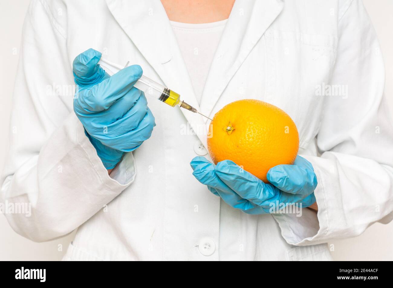 Syringe injecting orange fruit hi-res stock photography and images - Alamy