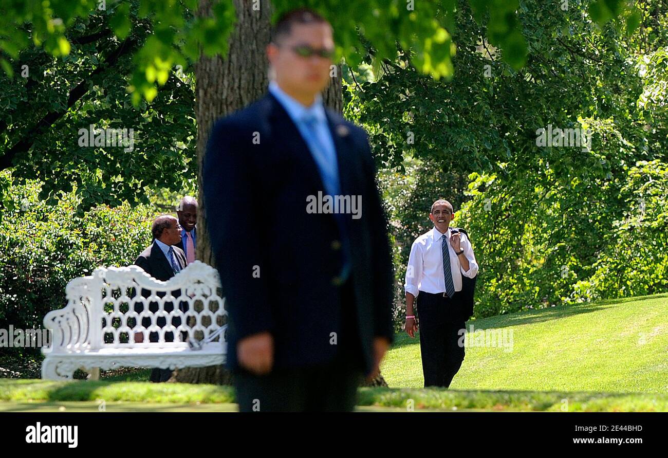 US President Barack Obama walks while enjooying the nice weather on the ...