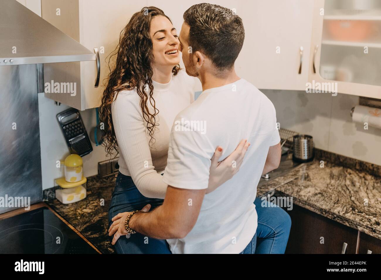 Woman sitting on counter hi-res stock photography and images - Alamy
