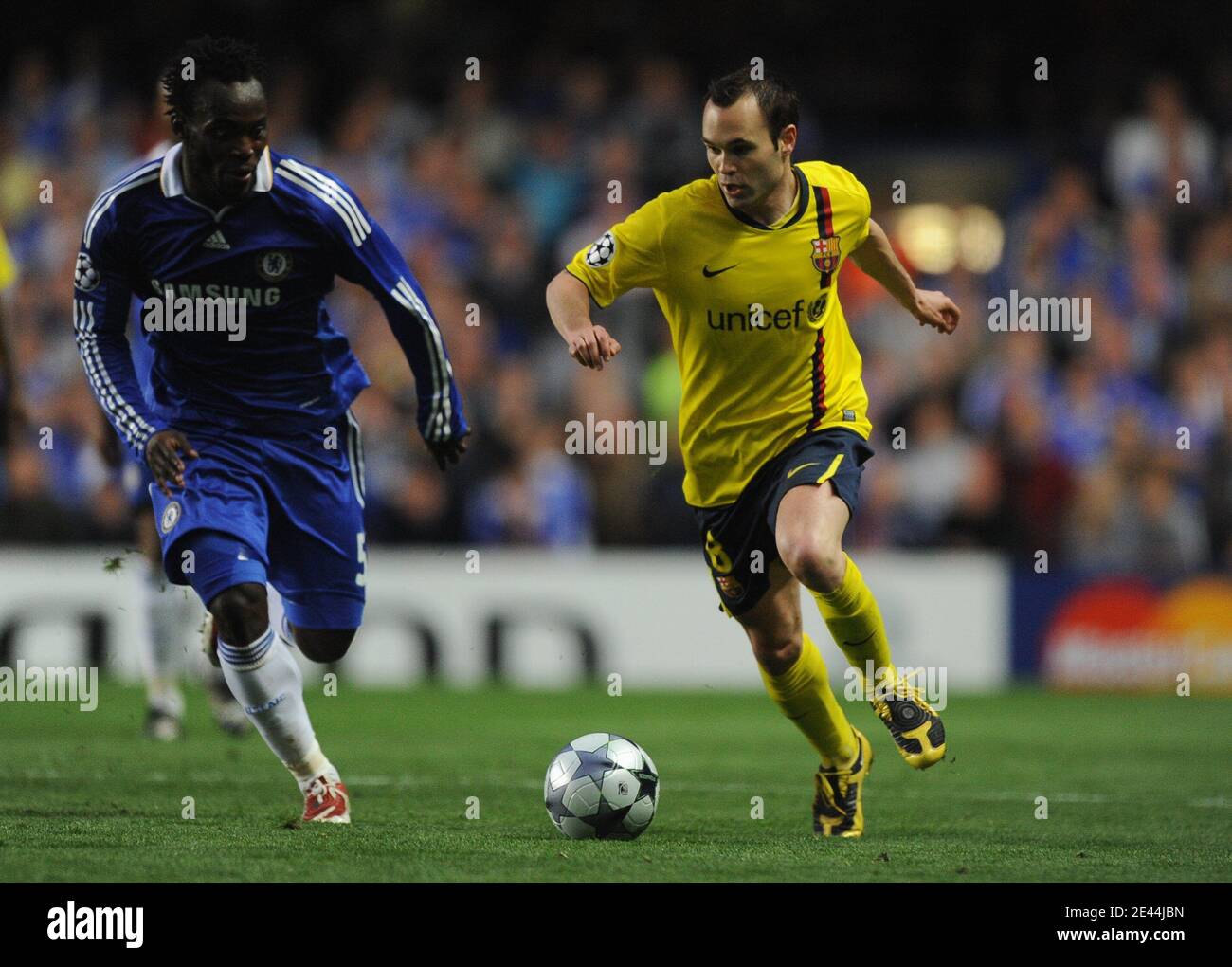Chelsea's Michael Essien is challenged by Barcelona's Andres Iniesta ...