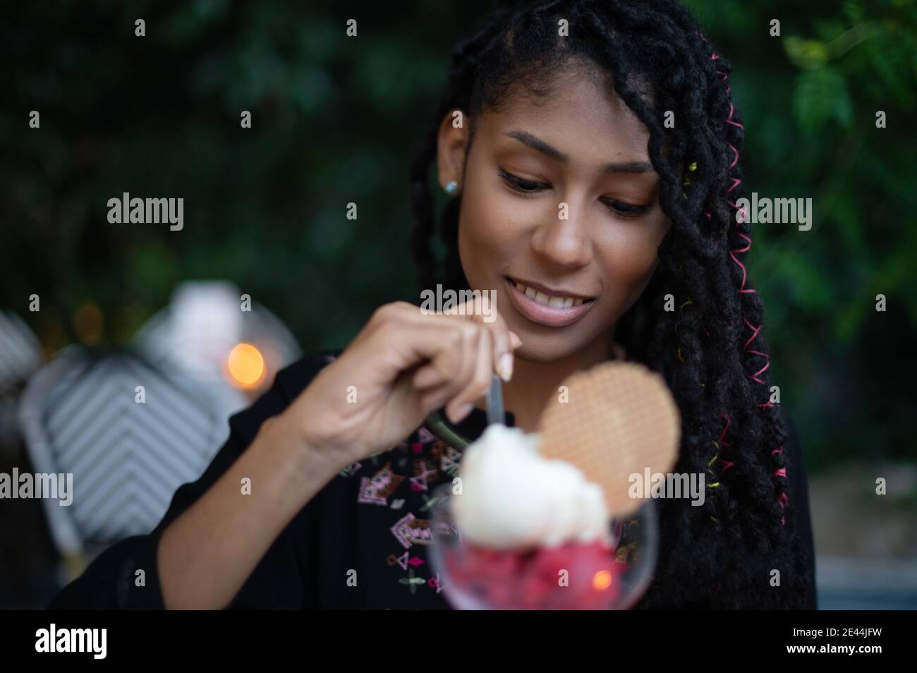 Happy young attractive afro latina Woman with dreads eating an ice ...