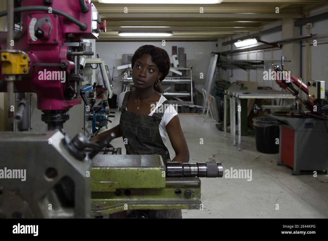 Professional young African American female mechanic processing detail ...