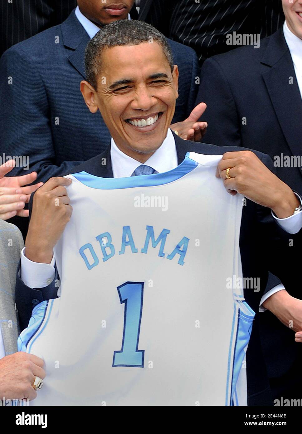 US President Barack Obama receives a jersey from Coach Roy Williams ...