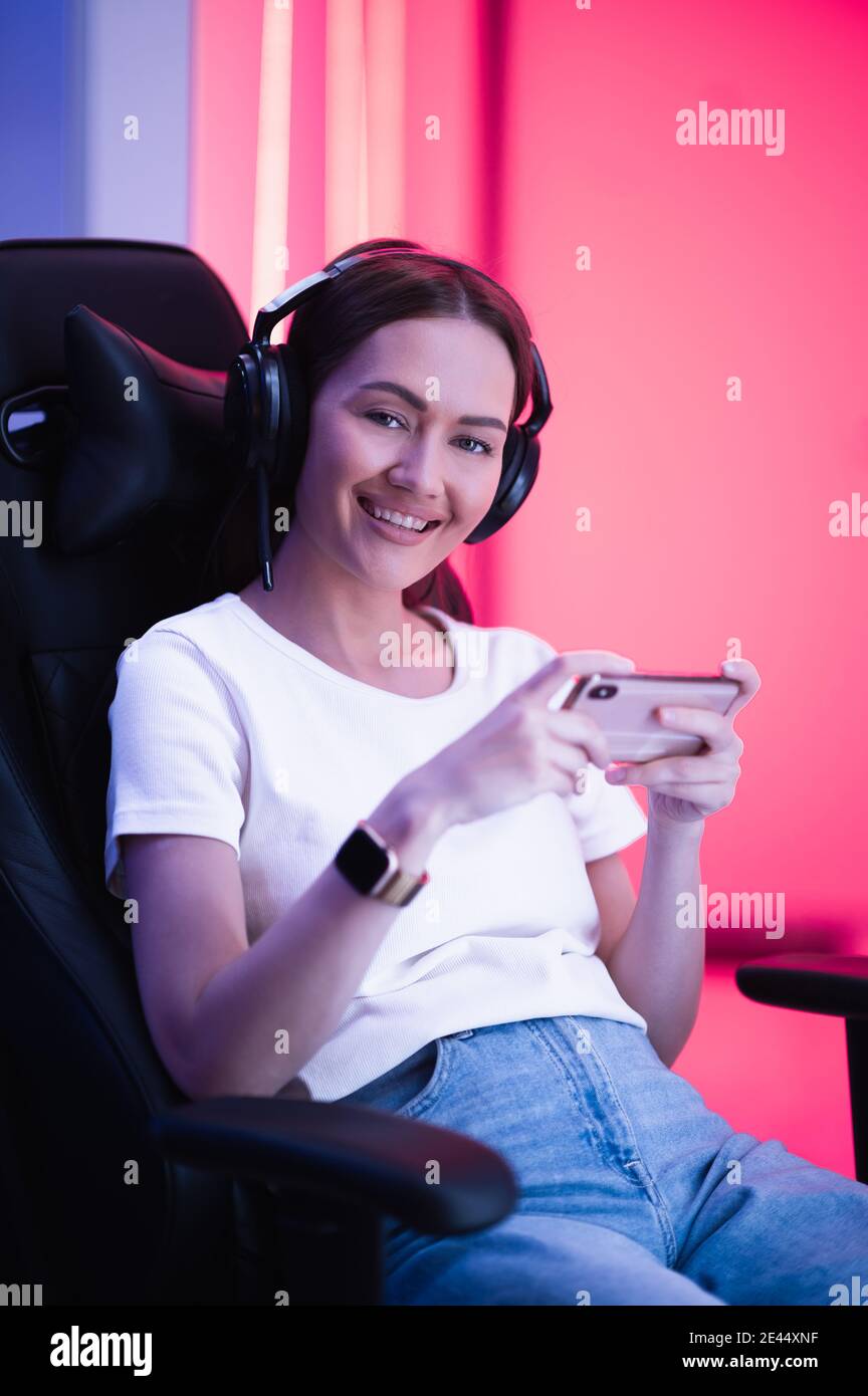 Cybersport gamer playing mobile game on the smart phone sitting on a ...