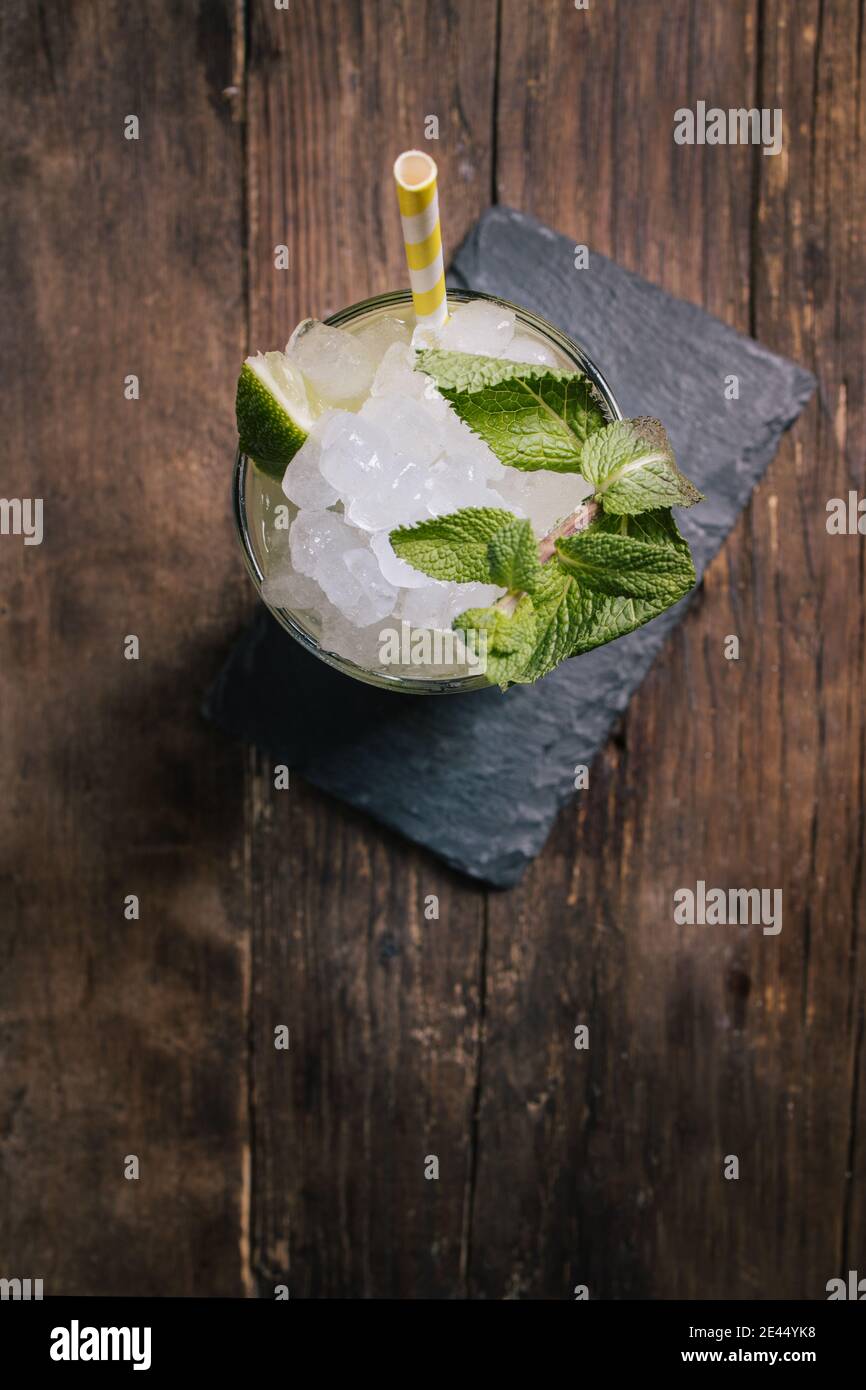 Glass with cold alcohol Mojito cocktail with rum and fresh lime served ...