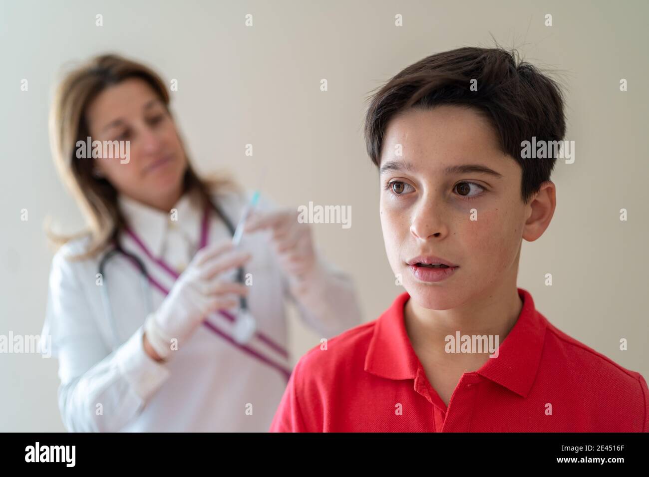 Female doctor making injection of vaccine from coronavirus for scared ...