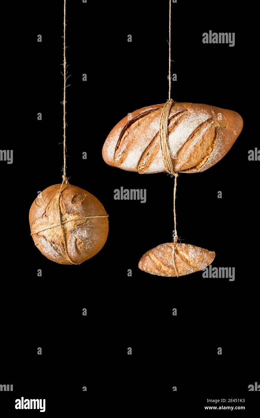 Loafs and pieces of fresh artisan crispy bread of various shapes and ...