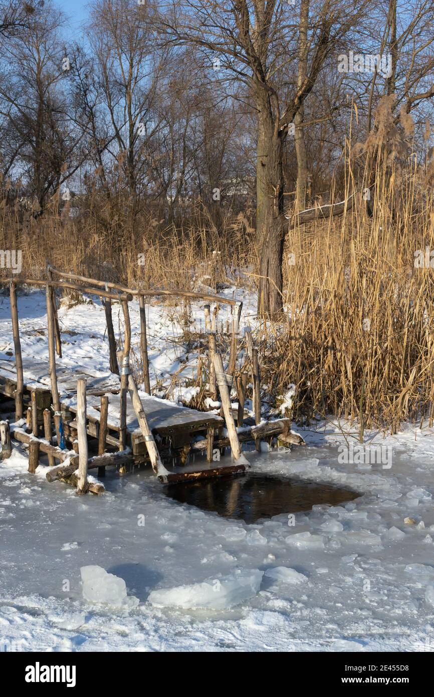 An ice-hole on a frozen river. Place for dipping. Ice bathing concept ...