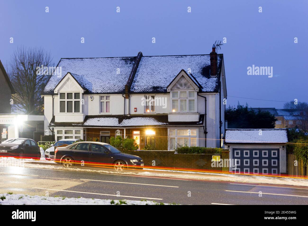 Semi detached house covered in light snow over night in cold January ...