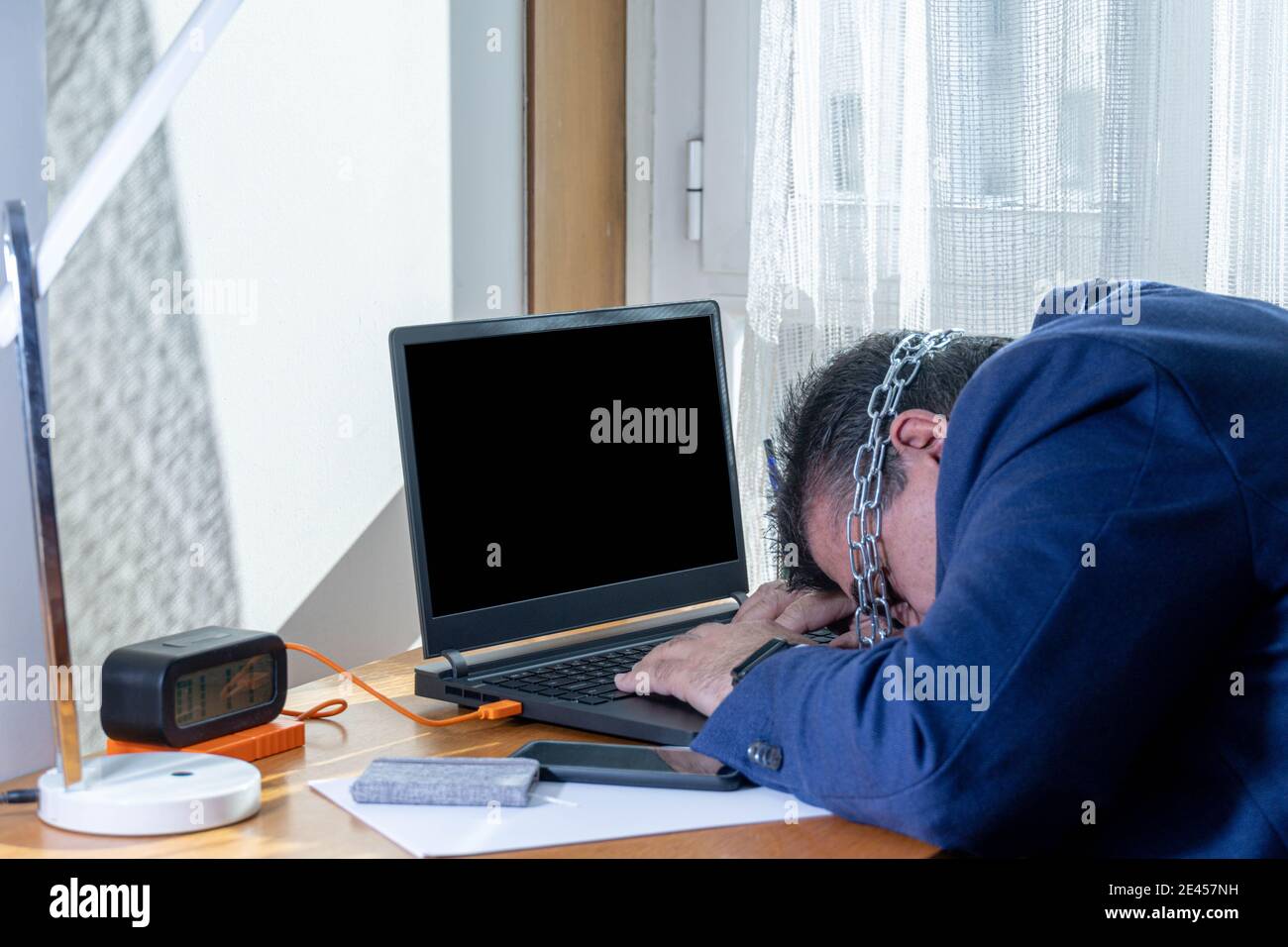 selective focus of an exhausted and sleeping businessman chained to his ...