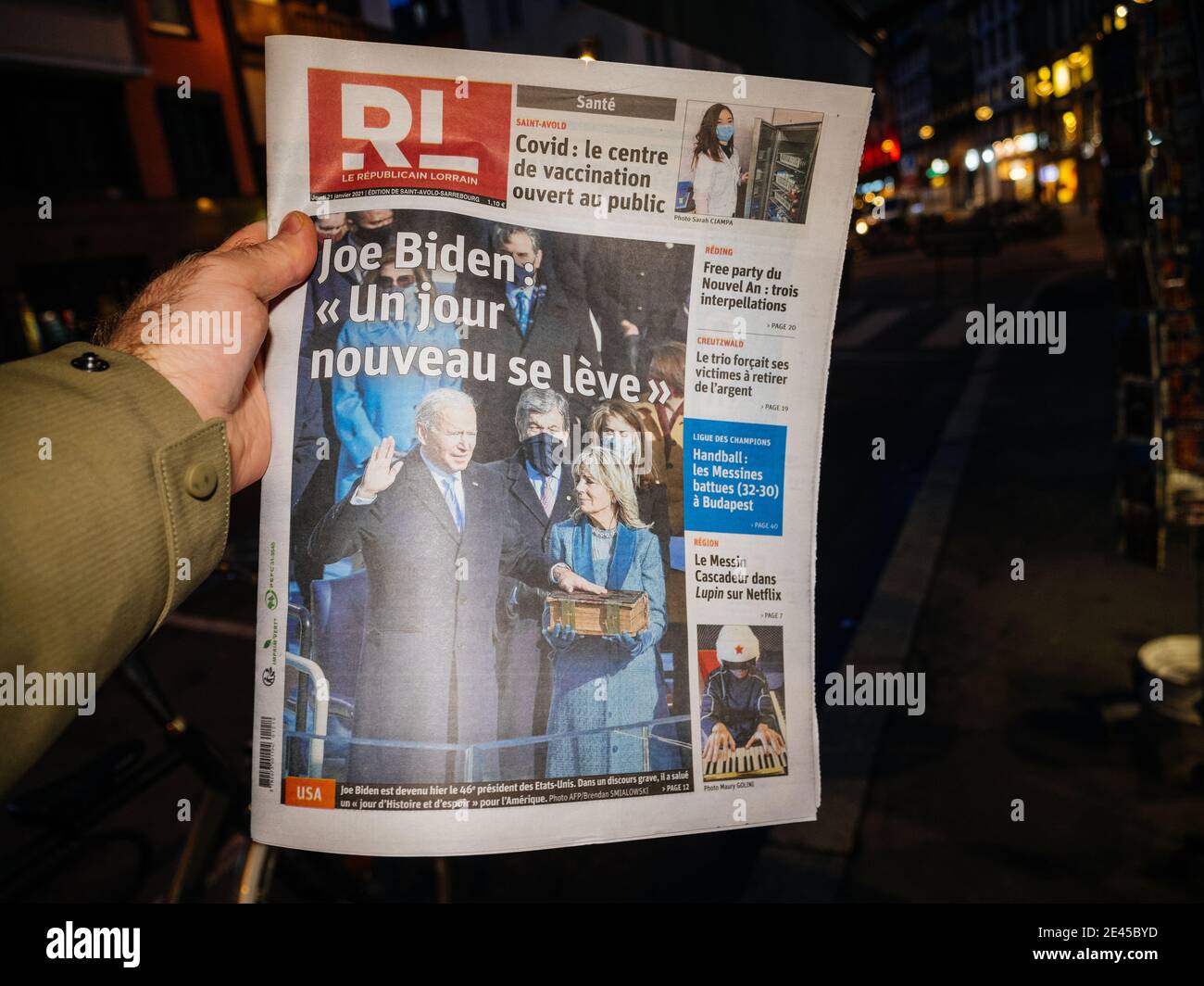 Paris, France - Jan 21, 2021: POV man buying French newspaper headline ...