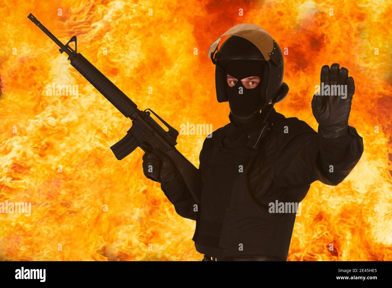 Riot police officer in black pattern tactical uniform, ammunition ...