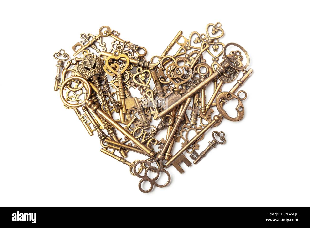Old, vintage keys in the shape of a heart isolated on white bacground ...