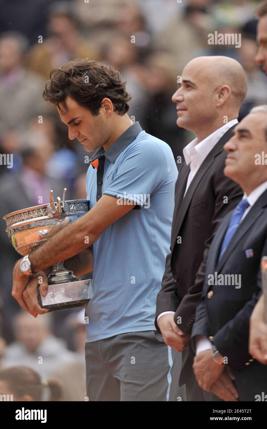 Switzerland's Roger Federer holds the trophy following his victory ...