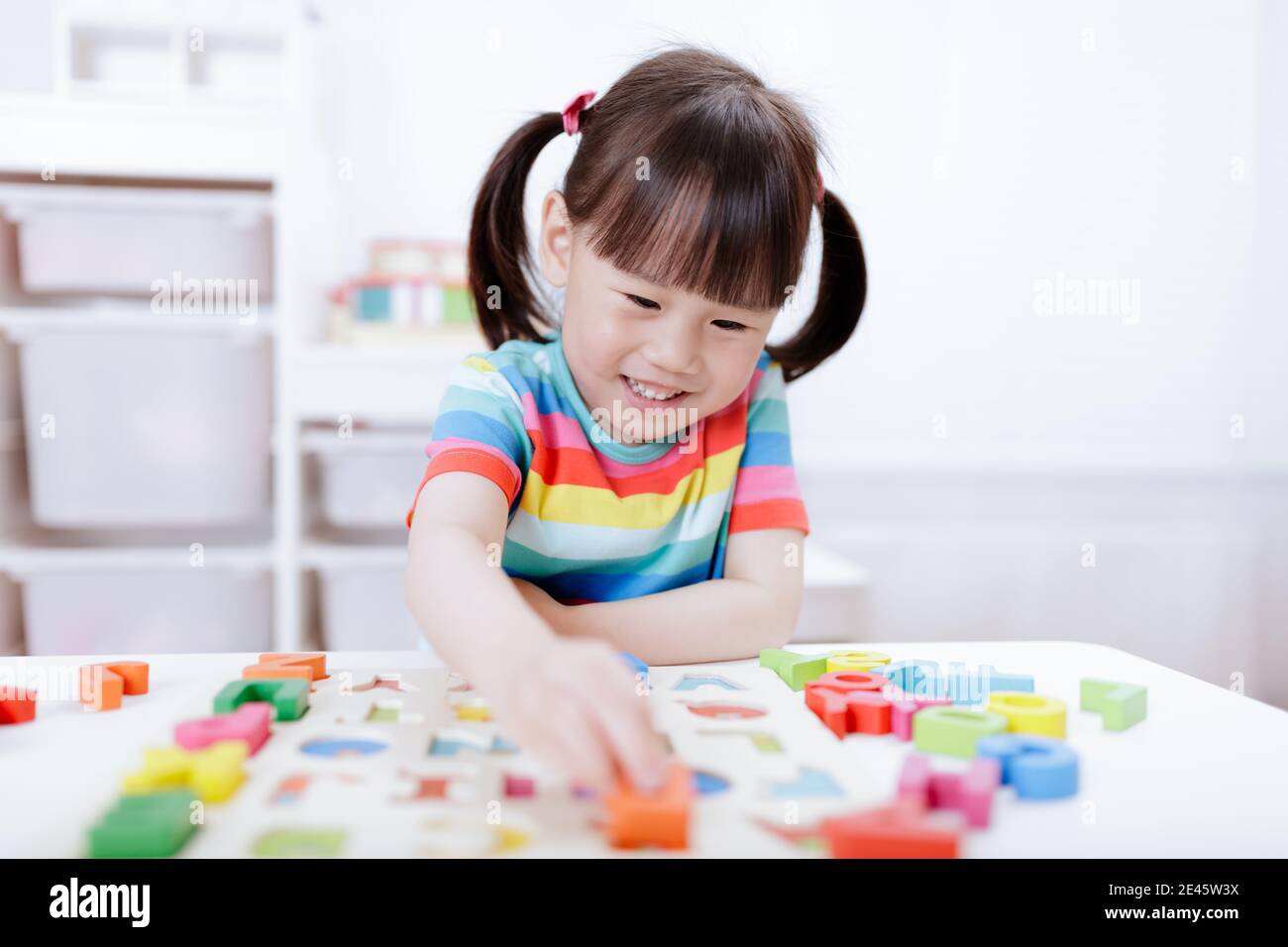 young girl learning letter blocks for homeschooling Stock Photo - Alamy