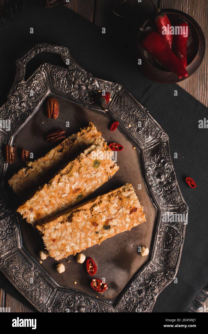 Vertical shot of healthy spicy cookies with different nuts and peppers ...