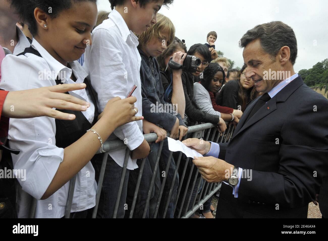 French President Nicolas Sarkozy salutes children during ceremony ...