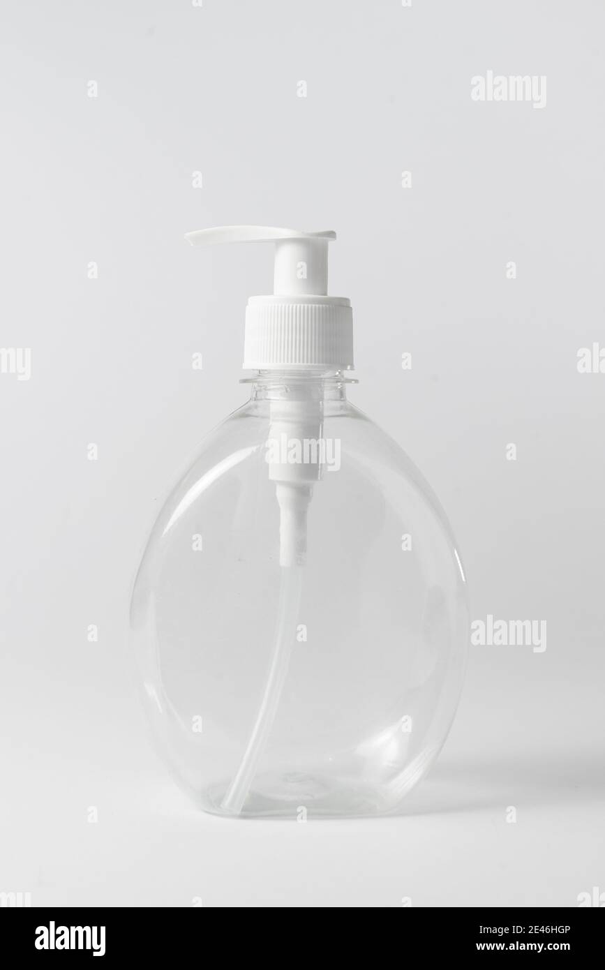 Isolated shot of an empty transparent bottle with a dispenser on white ...